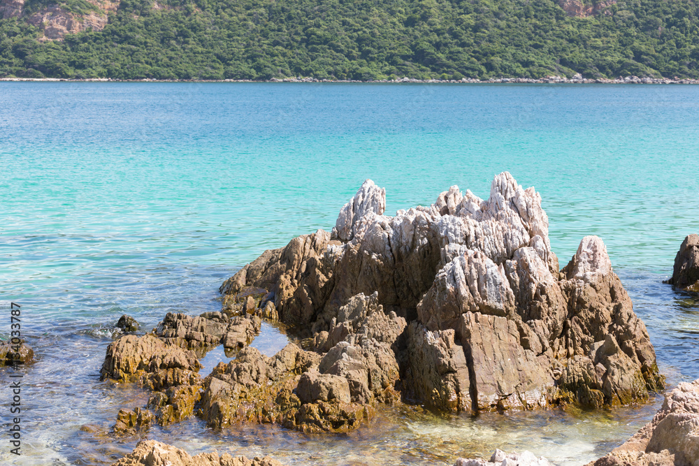 sharp riffs on the background of azure water Stock Photo | Adobe Stock