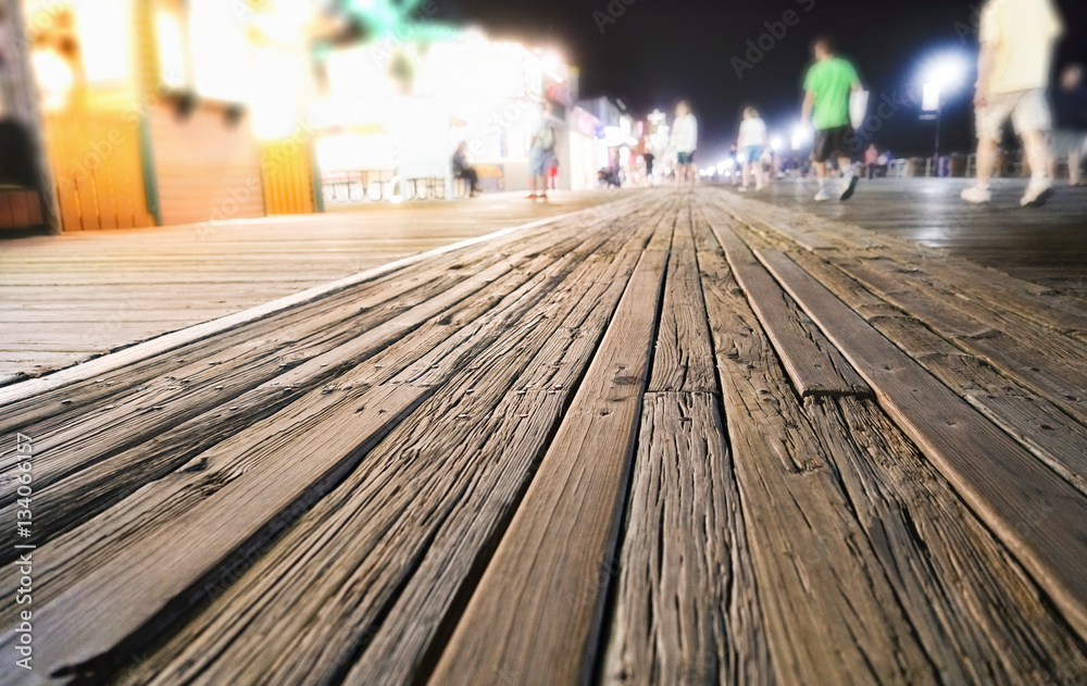 Boardwalk in perspective at the beach in New Jersey. Lights shining at ...