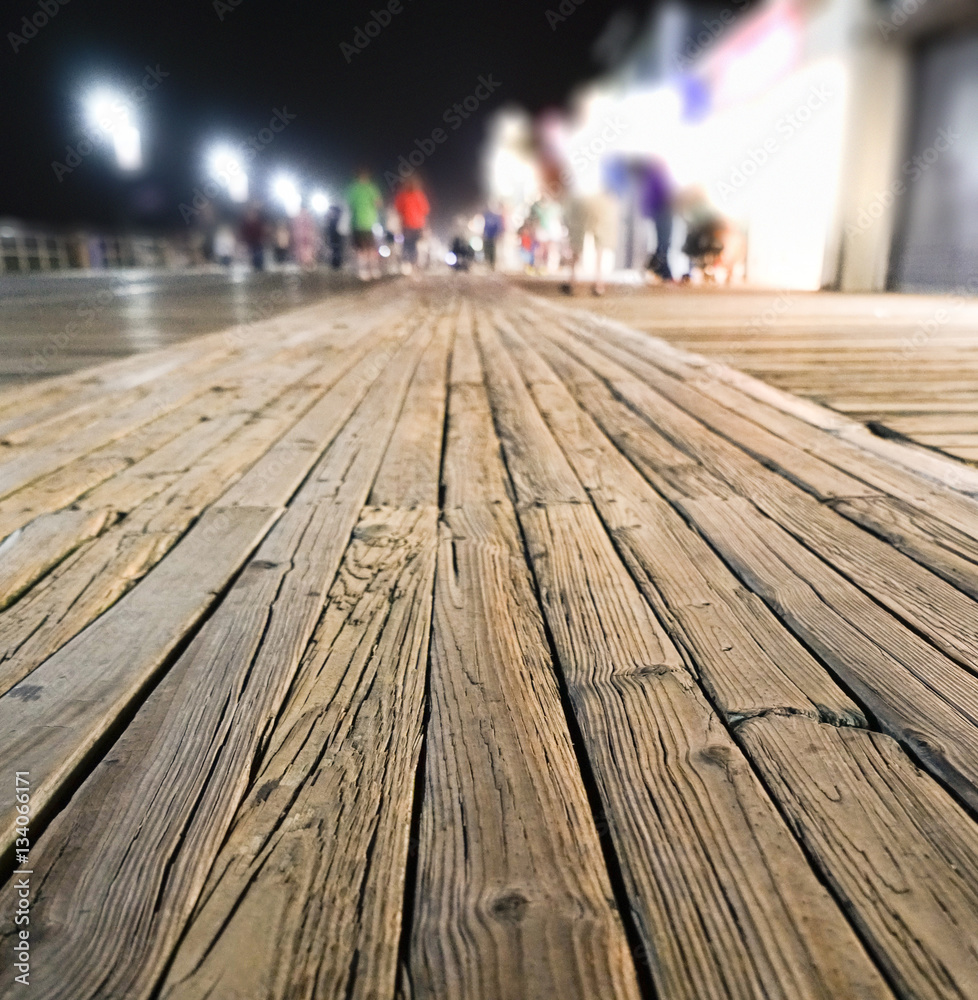 Boardwalk in perspective at the beach in New Jersey. Lights shining at ...