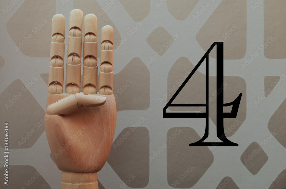 Articulated wooden hand with four fingers raised in allusion to number ...