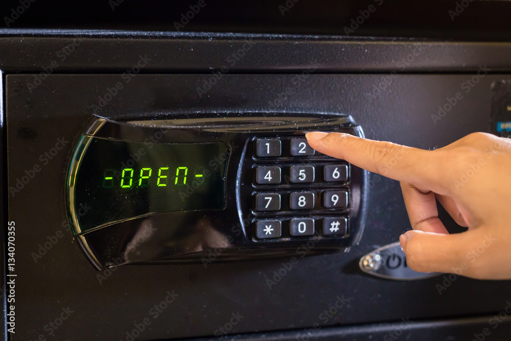 Hand press key on black safety box with open status Stock Photo | Adobe ...