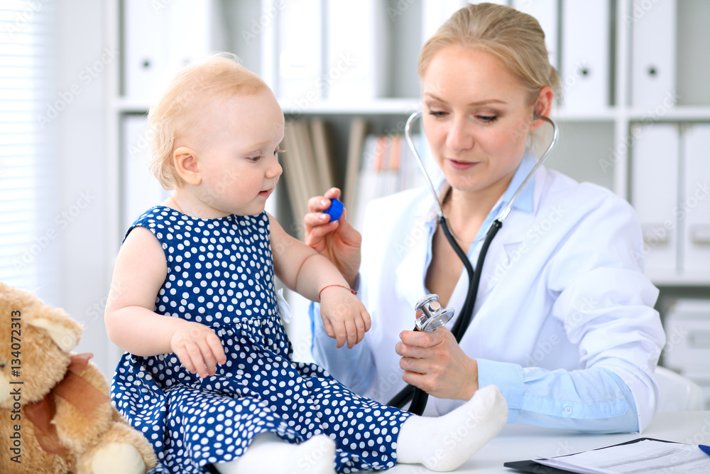 Pediatrician is taking care of baby in hospital. Little girl is being ...