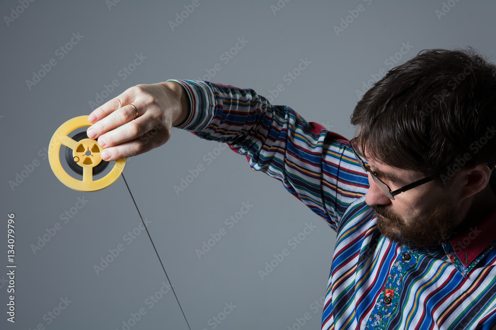 Bearded man looks at 8mm film Stock-Foto | Adobe Stock