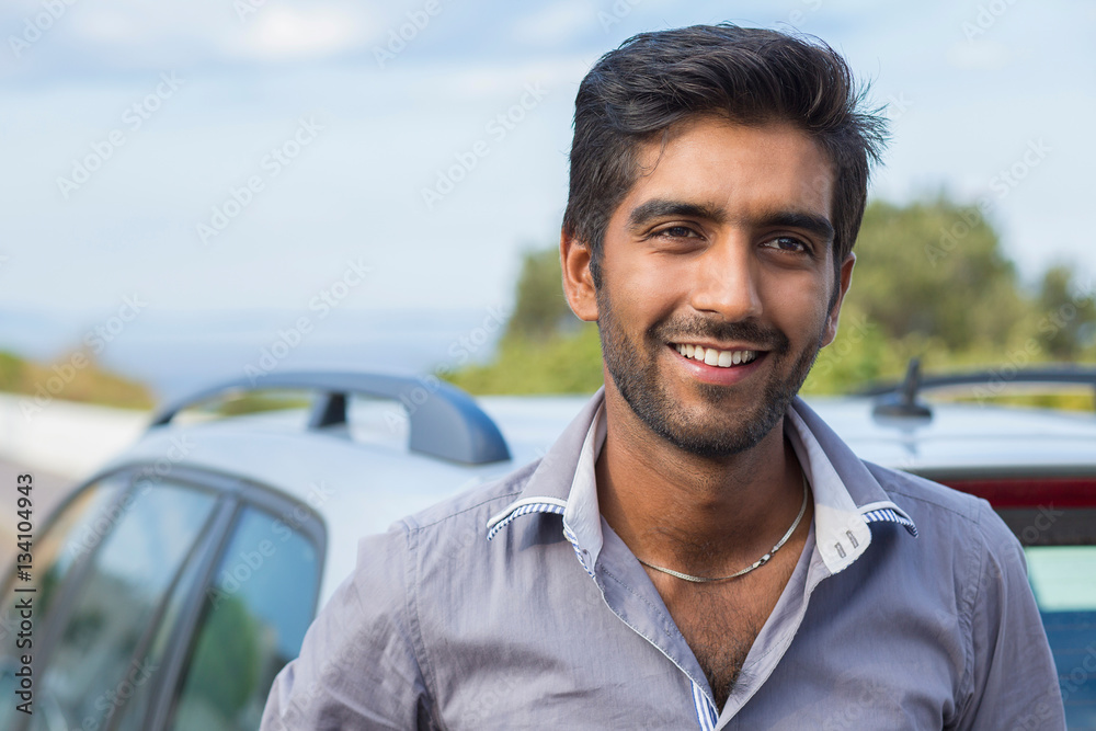 Happy man driver smiling standing by his new car isolated outside ...