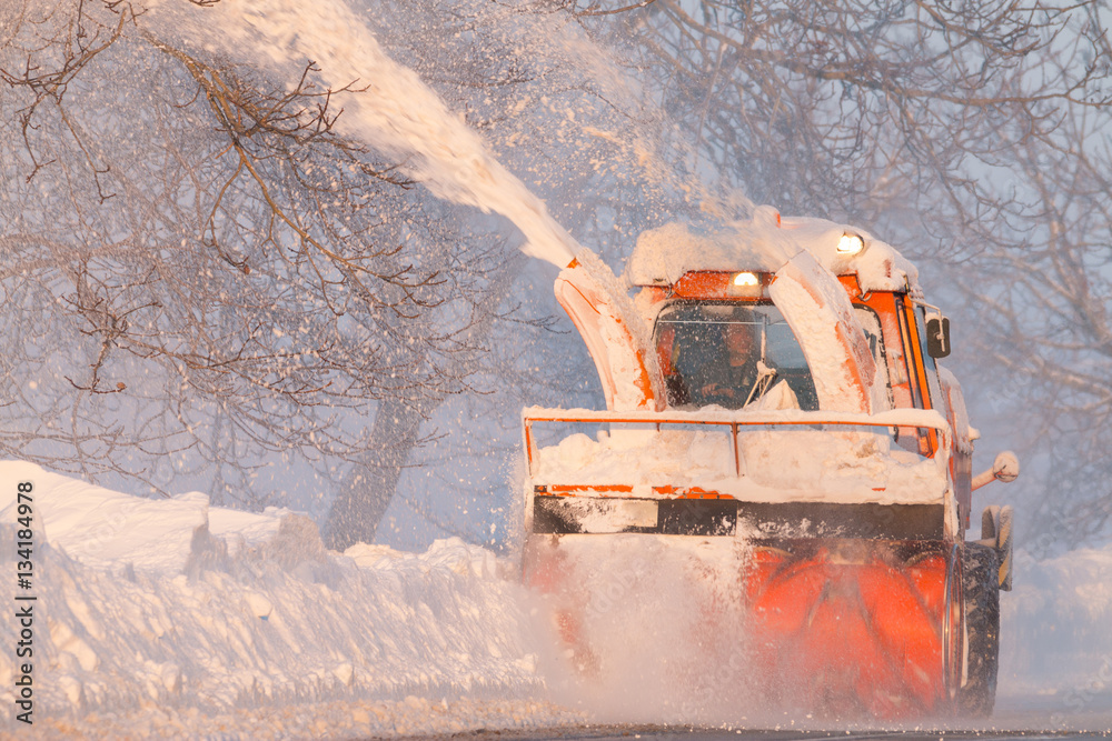 Snow truck cleaning snow from the road and streets working at sunset ...