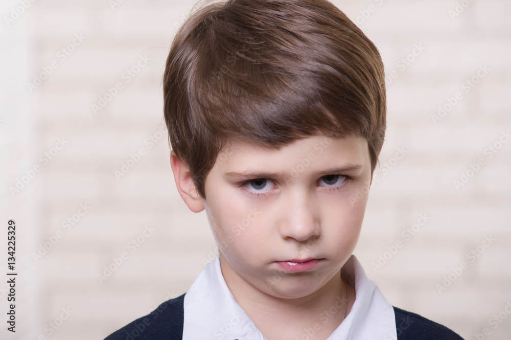 Portrait of a beautiful, caucasian boy on a bright background in bad ...
