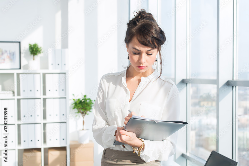 Close-up portrait of a caucasian female office assistant at her ...