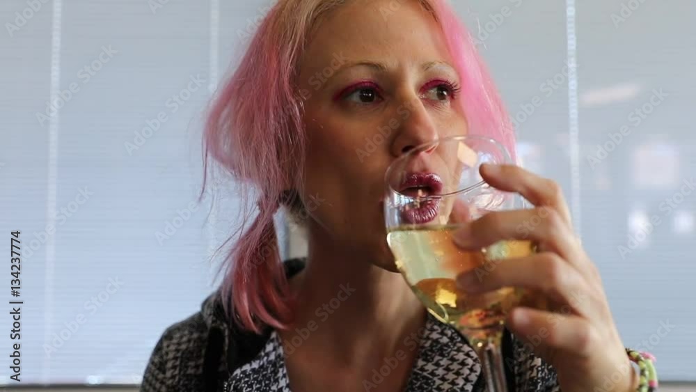 Slow motion of a smiling caucasian drunk woman laughing and tasting ...