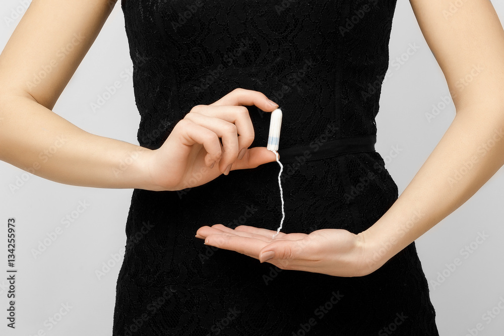 Beautiful young smiling girl with long hair holding a female swab ...