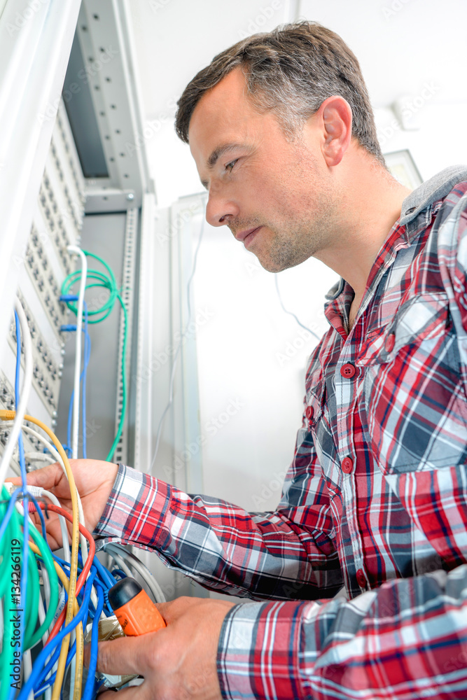 Man connecting wires Stock Photo | Adobe Stock