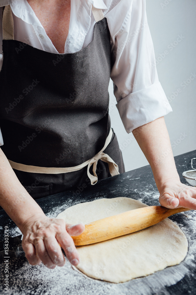 A person on kitchen rolling a pastry with the pin. Stock Photo | Adobe ...
