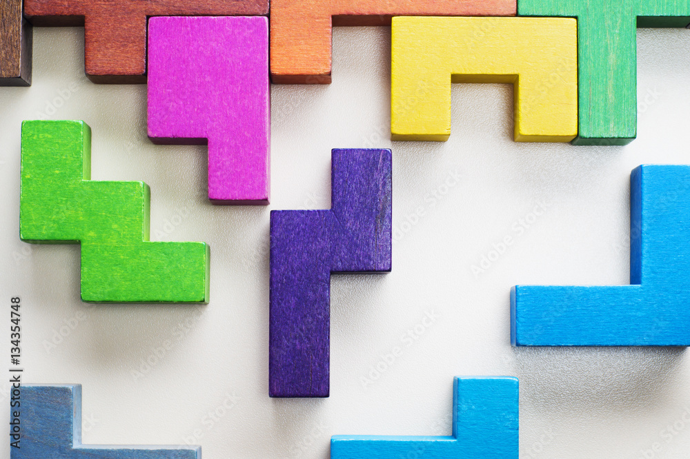 Different colorful shapes wooden blocks on beige background, flat lay ...