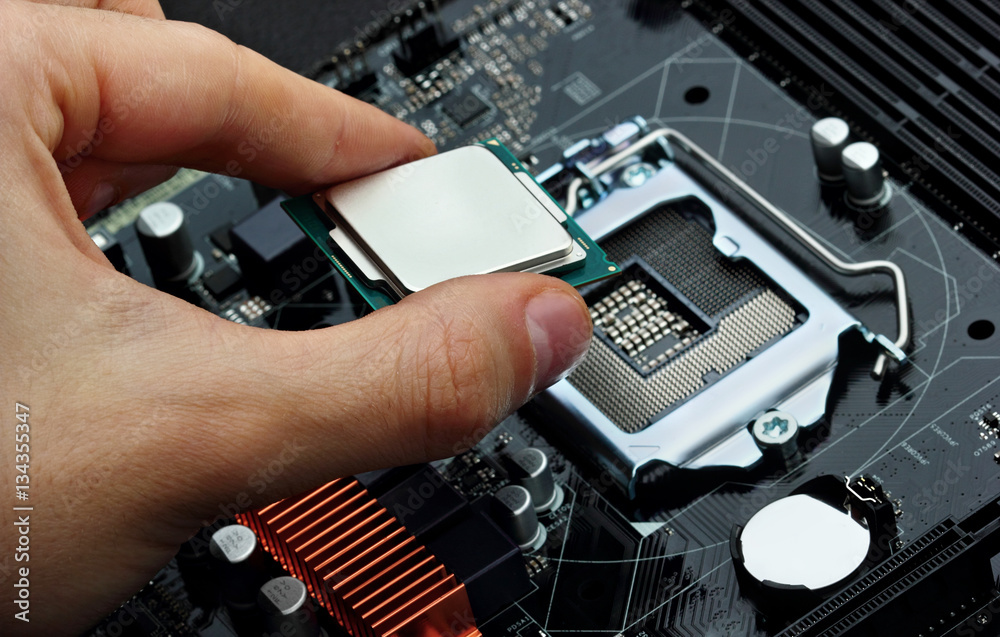 Plug in CPU microprocessor to motherboard socket. Technological ...