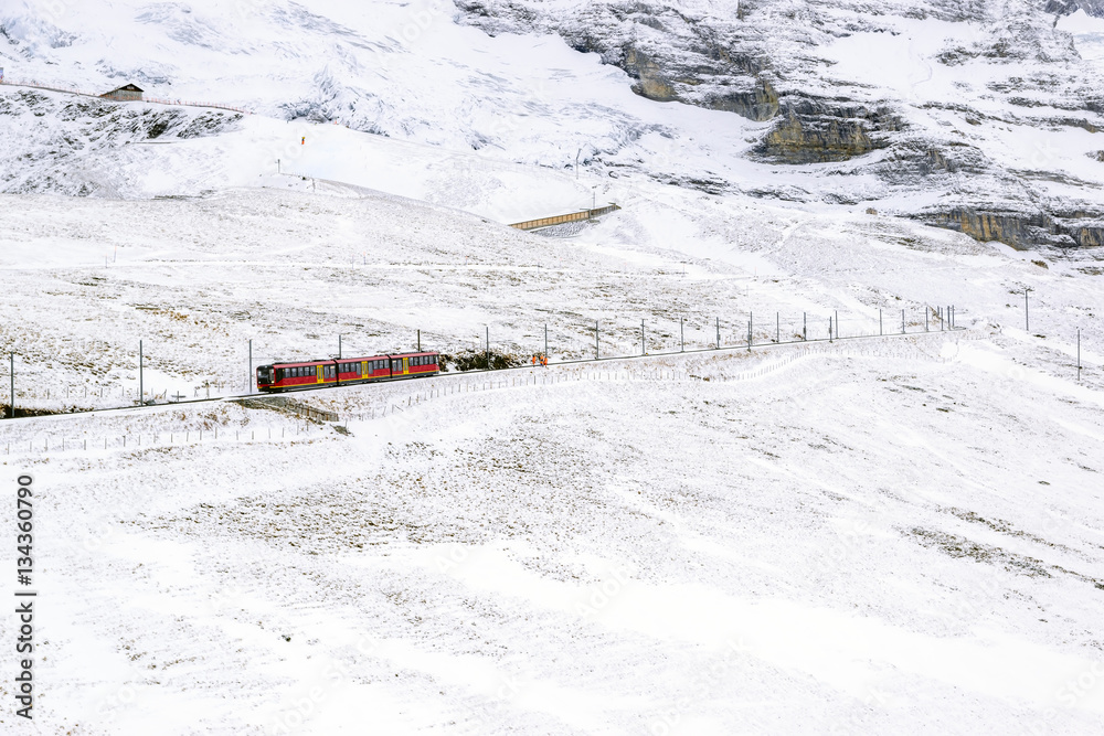 Passenger train in winter with snow on the mountains in Switzerland ...