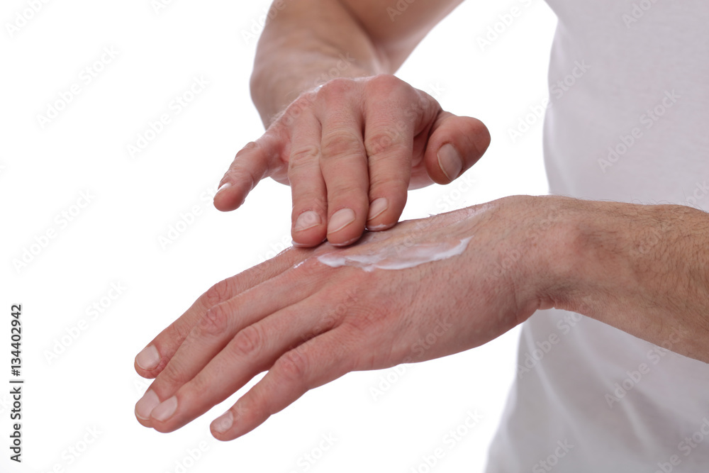 Foto Stock Man applying moisturizer cream on hands, dry skin on white ...