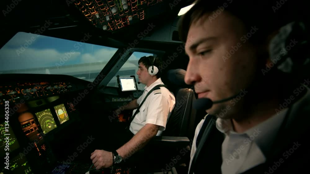 Side view of Airbus A319 A320 A321 cabin. Captain and co-pilot perform ...