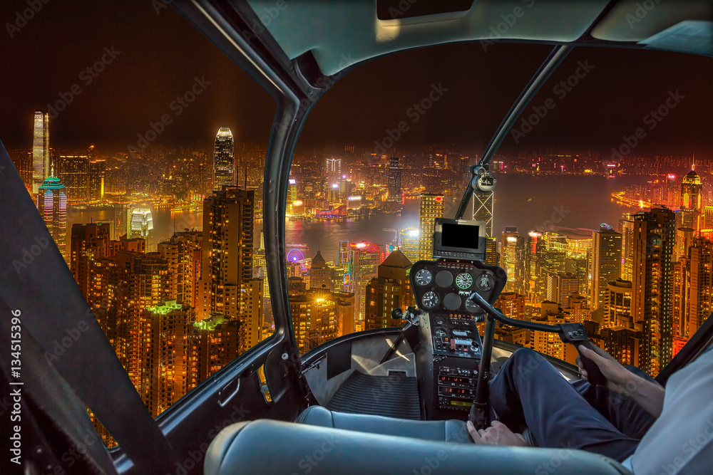 Aerial view inside helicopter cockpit night flight on Hong Kong ...