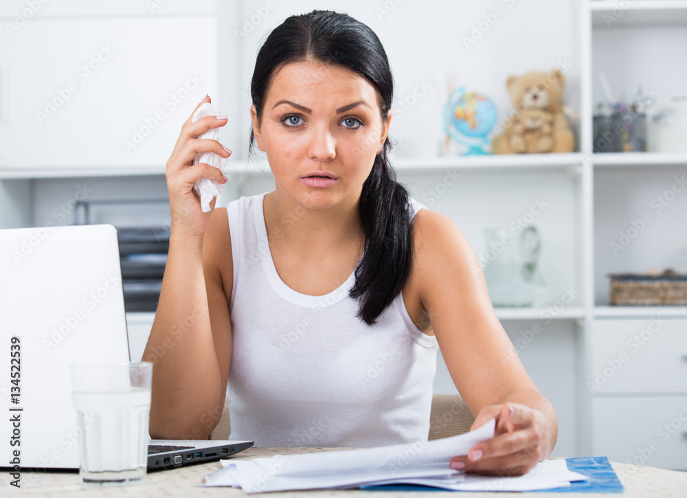 Sad woman working at laptop Stock Photo | Adobe Stock