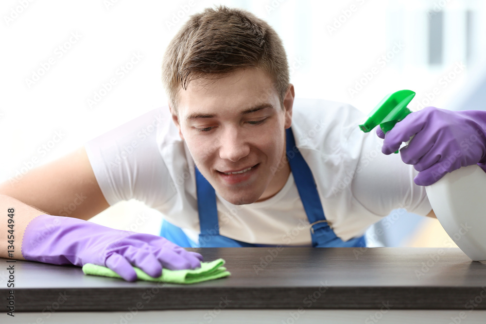 Closeup of young man cleaning table Stock Photo | Adobe Stock