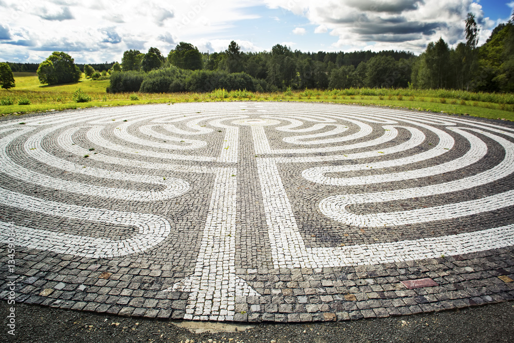 Gothic labyrinth from black and white cobble-stones in the field ...