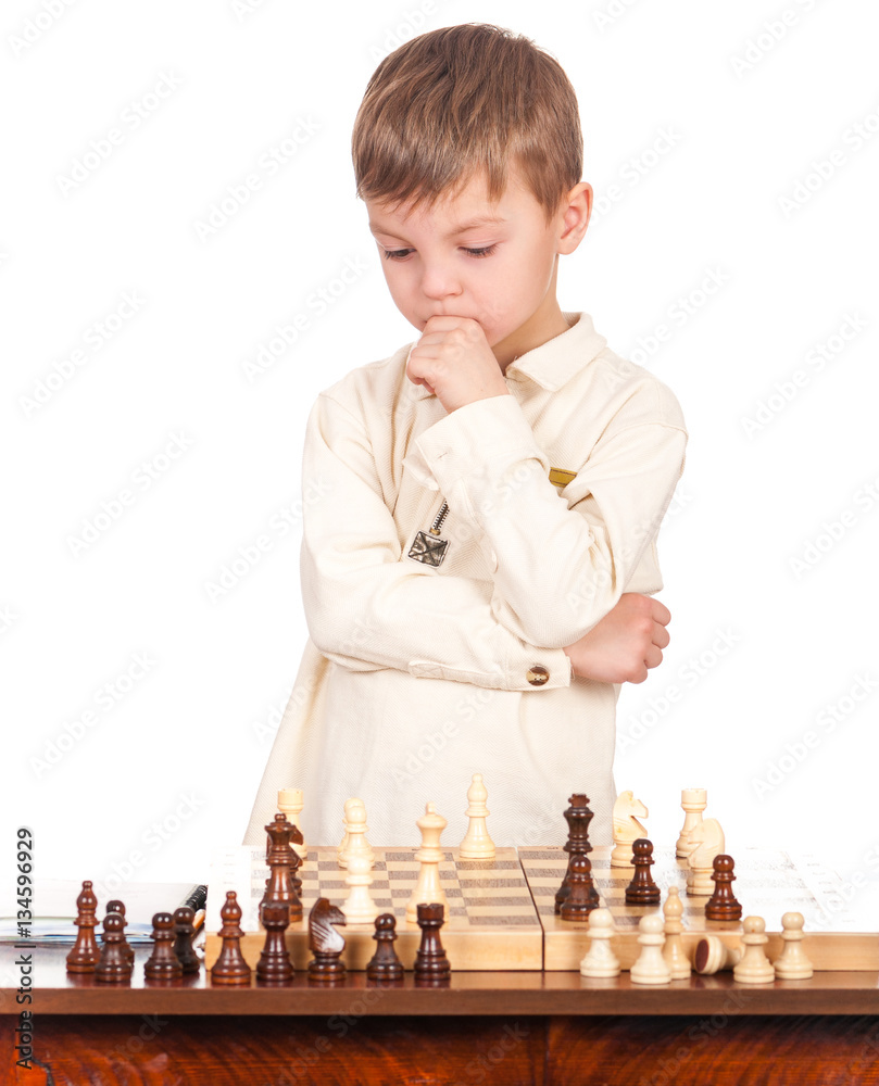 Emotional portrait of caucasian little boy with chessboard. Funny child ...