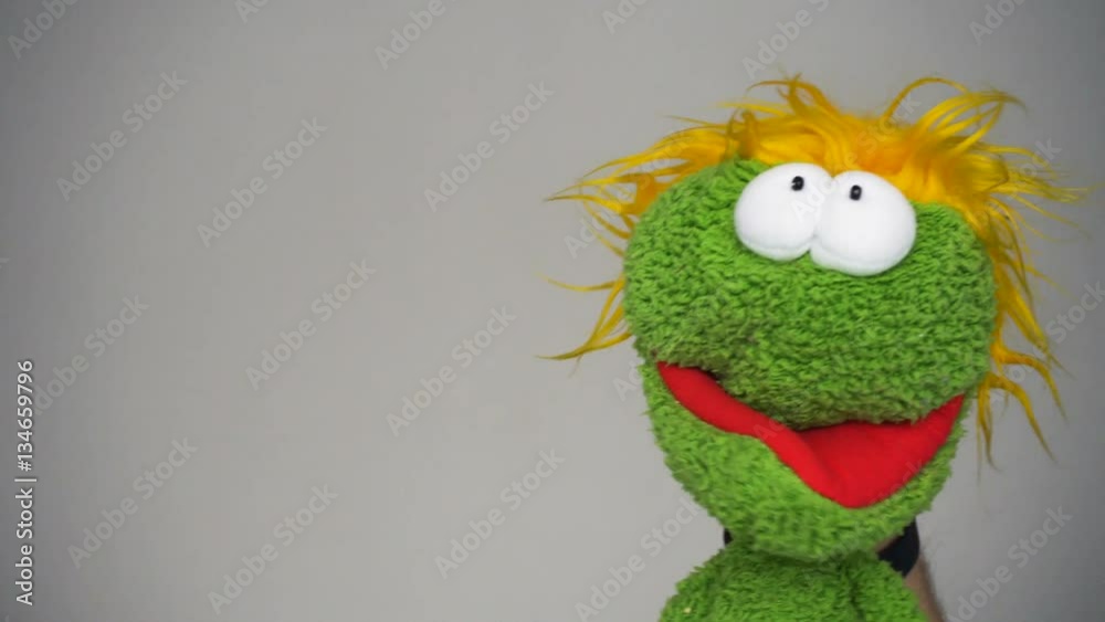 Funny green puppet with funny face Stock Video | Adobe Stock