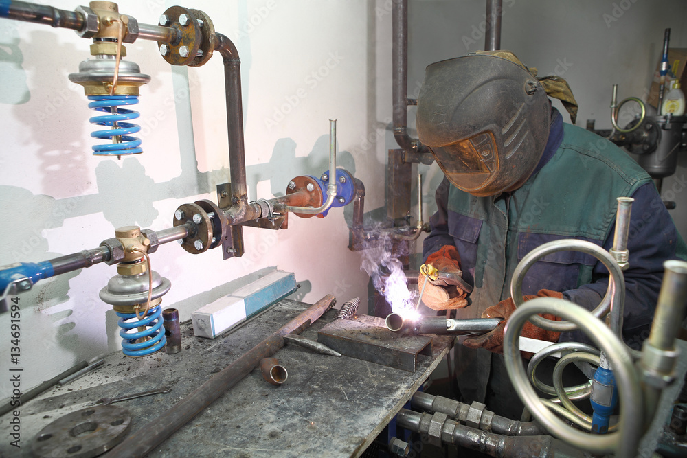 Welder electric arc welding using personal protective equipment, Stock ...