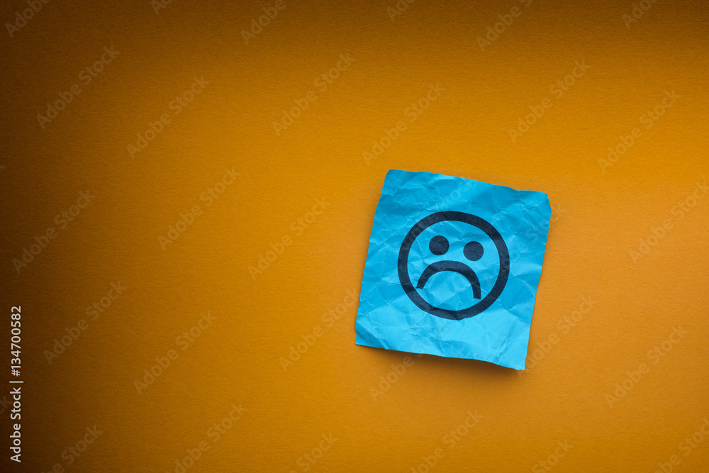 Blue paper note with sad face on a yellow paper background Stock Photo ...