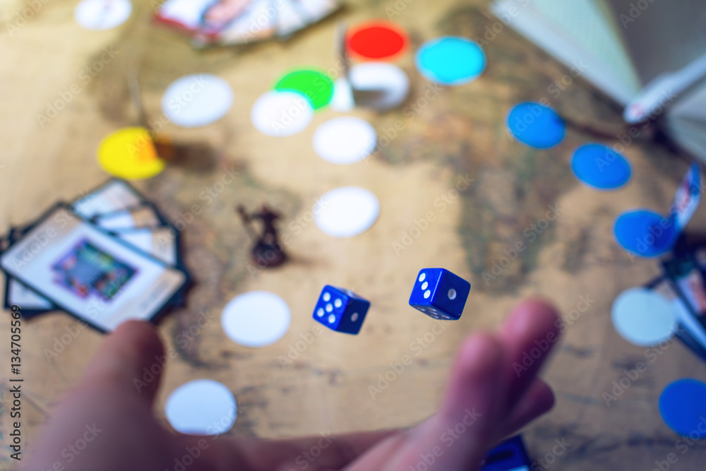 hand throws the dice on background world map Board games Stock Photo ...