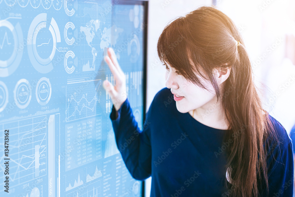 Asian Business economic watch. Asian women looking at display report ...