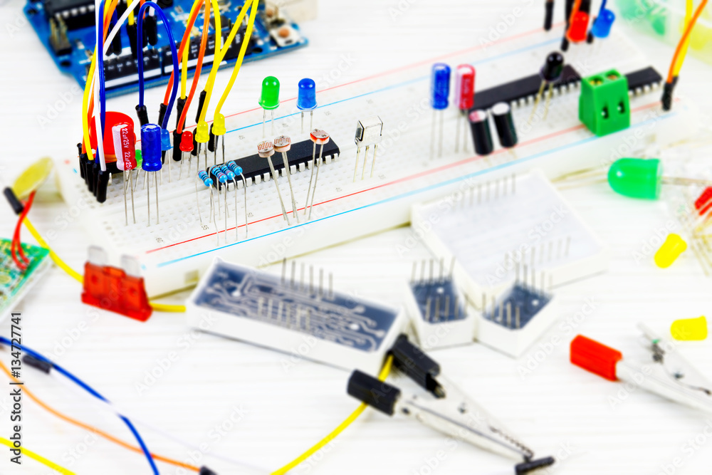 Prototype board with microcontrollers, chips, resistors and light ...
