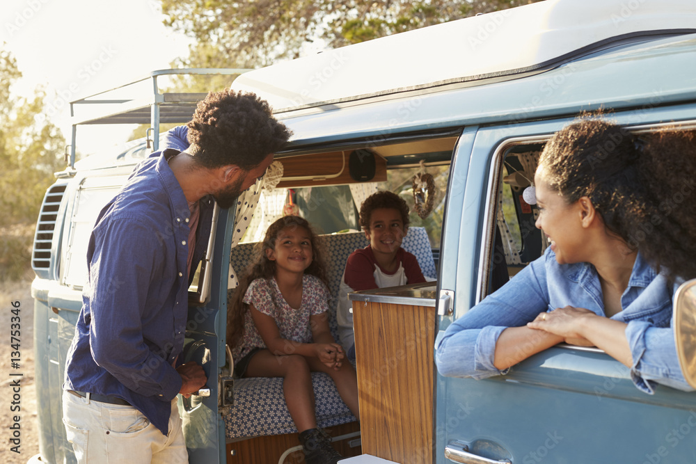 Family on a road trip making a stop in their camper van Stock Photo ...