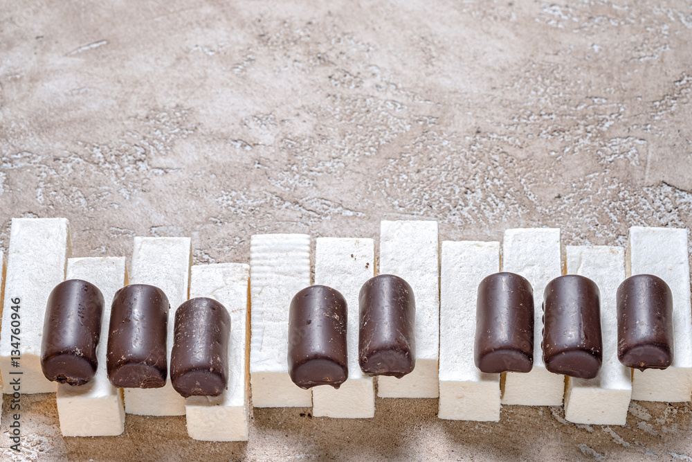 Piano keys laid out chocolates candy and marshmallows paste, on a ...