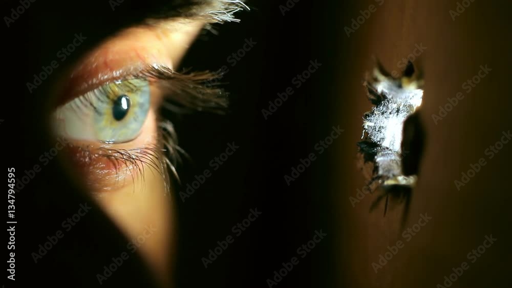 Male eye looking through hole. Horror scene surveillance. Stock Video ...