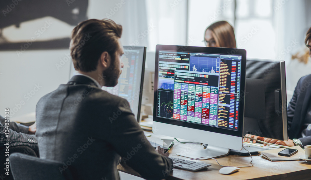 Broker analysing stock market on his computer. Stock-Foto | Adobe Stock