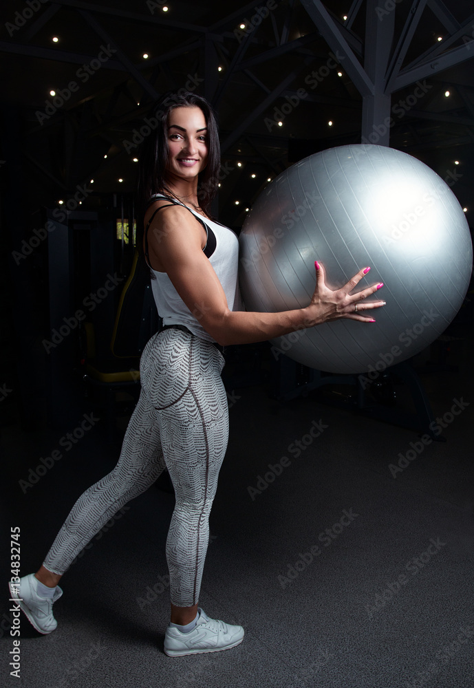 young girl with sexual inflated figure, in the gym holding a fit Stock ...