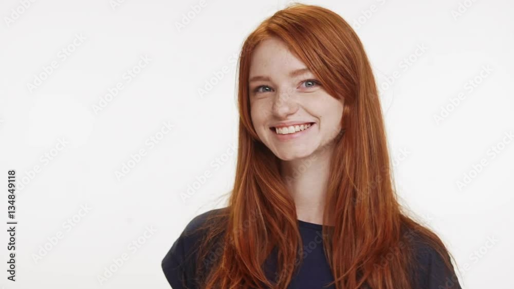 Smiling cute redhead Caucasian teenage girl showing ok on white ...