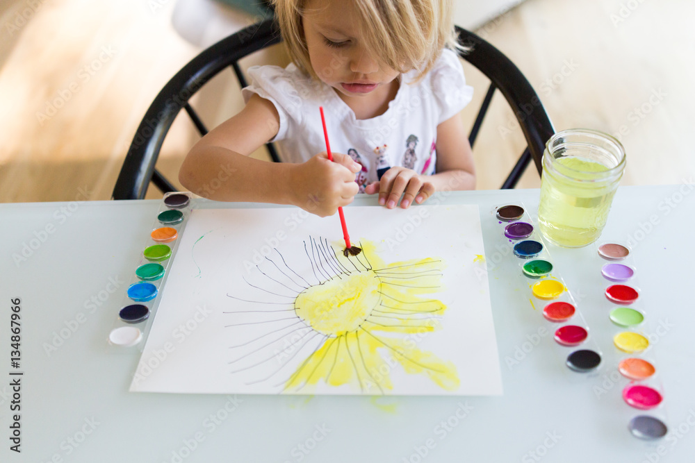 Child painting sun with watercolors Stock Photo | Adobe Stock
