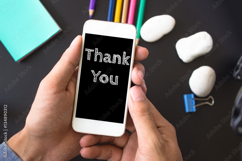 Thank you, text message on screen at hands take smartphone, black table ...