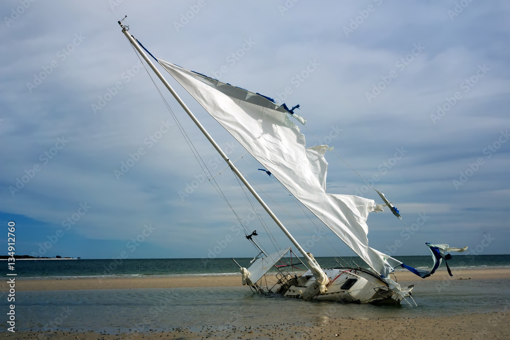 Broken yacht with a torn sail aground. Gulf Coast, Florida, St. Stock ...