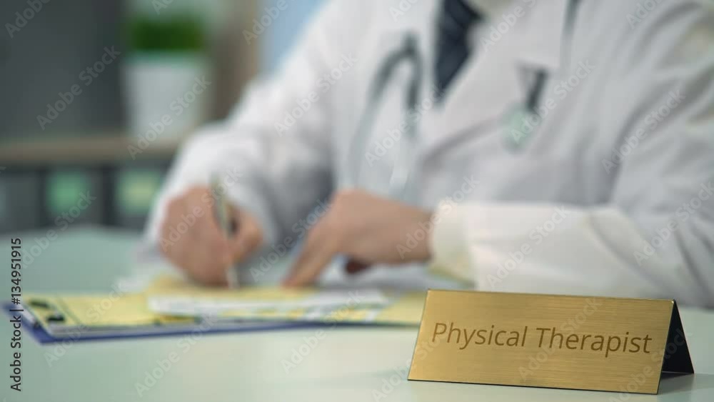 Physical therapist writing prescription, completing documentation in ...