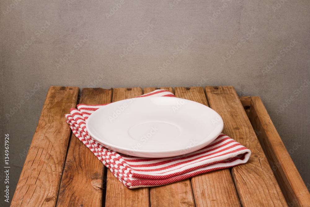 Background with empty plate on tablecloth and wooden table over rustic ...
