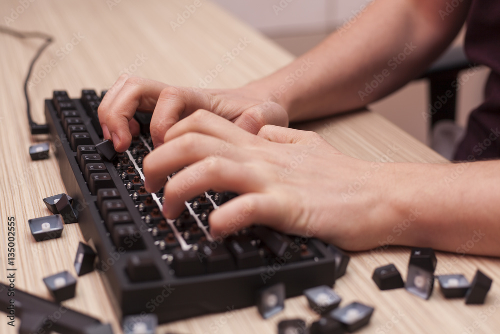 Man breaks a mechanical computer keyboard by typing angrily Stock Photo ...