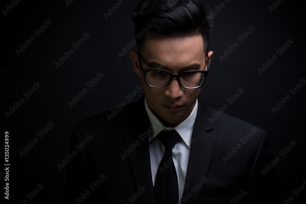 Businessman in black suit on isolated black background Stock Photo ...
