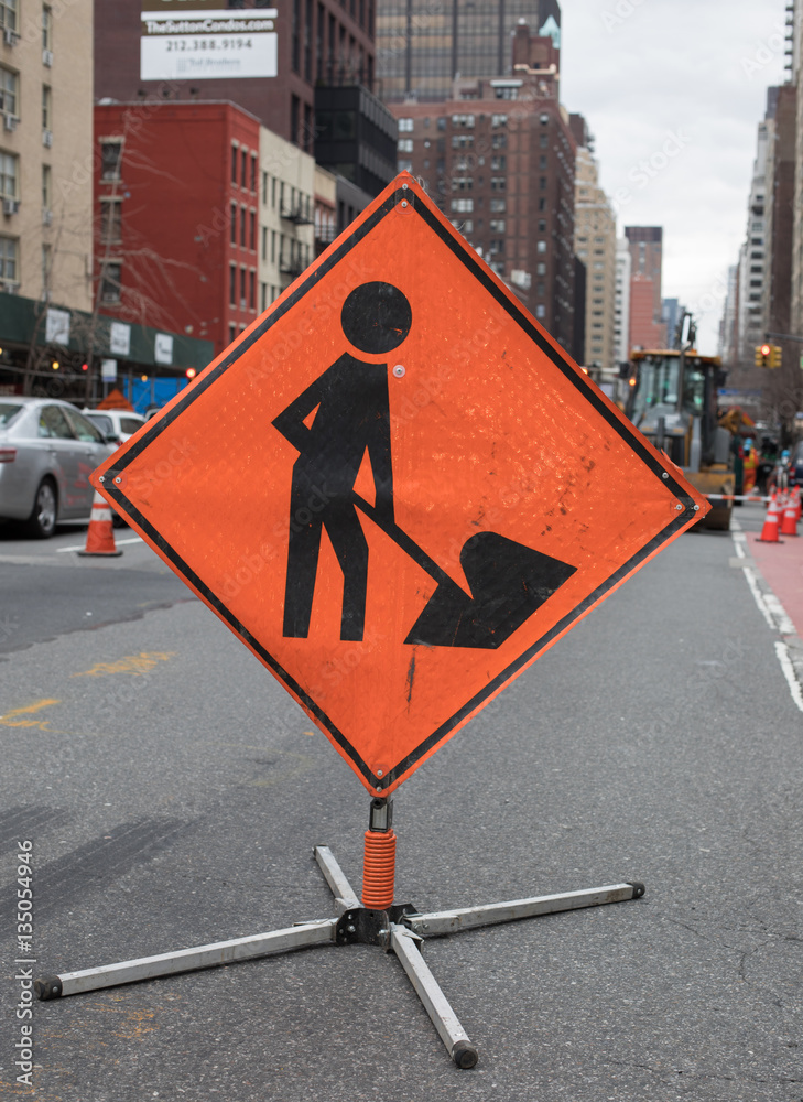 Orange Construction Sign of Man Shoveling on City Street Stock Photo ...