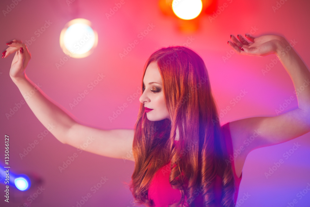 red-haired beautiful girl in a nightclub dancing Stock Photo | Adobe Stock
