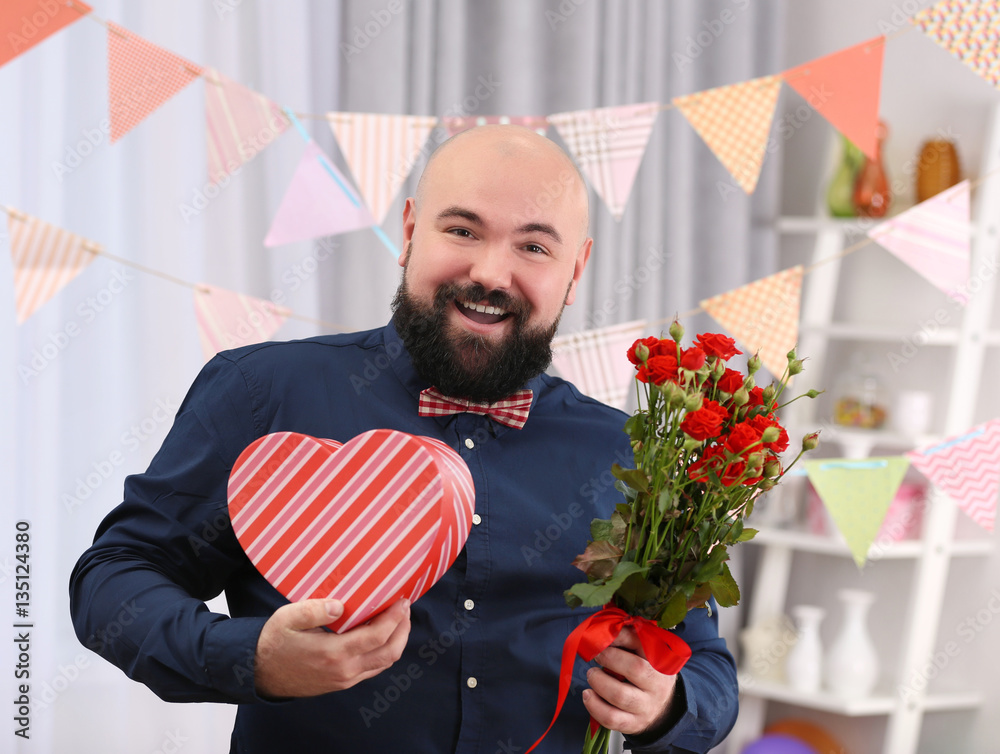 Funny fat man with giftbox and flowers at birthday party Stock Photo ...