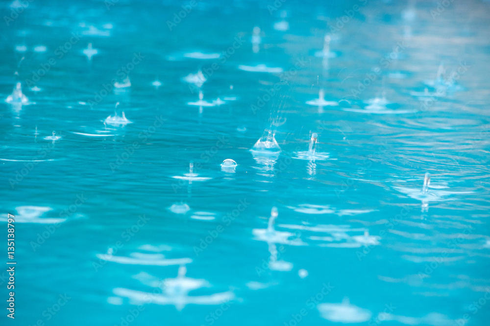 Close up of rain drops falling in the swimming pool. Stock Photo ...