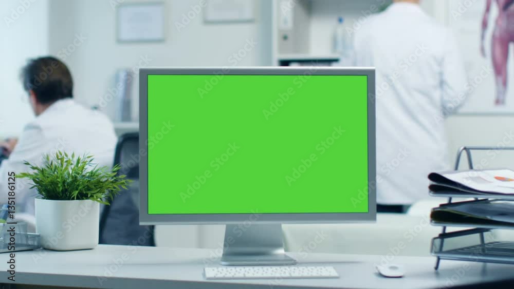 Close-up of a Monitor with Green Screen. Doctor Works with Folders ...
