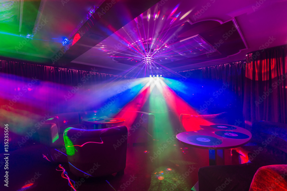Foto Stock Night club interior with colorful spot lights | Adobe Stock